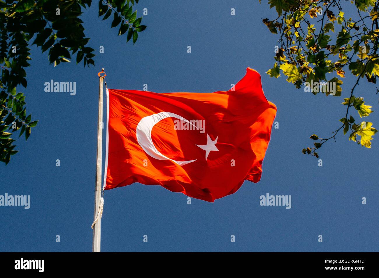 Turkish national flag with white star and moon on a pole in sky Stock ...