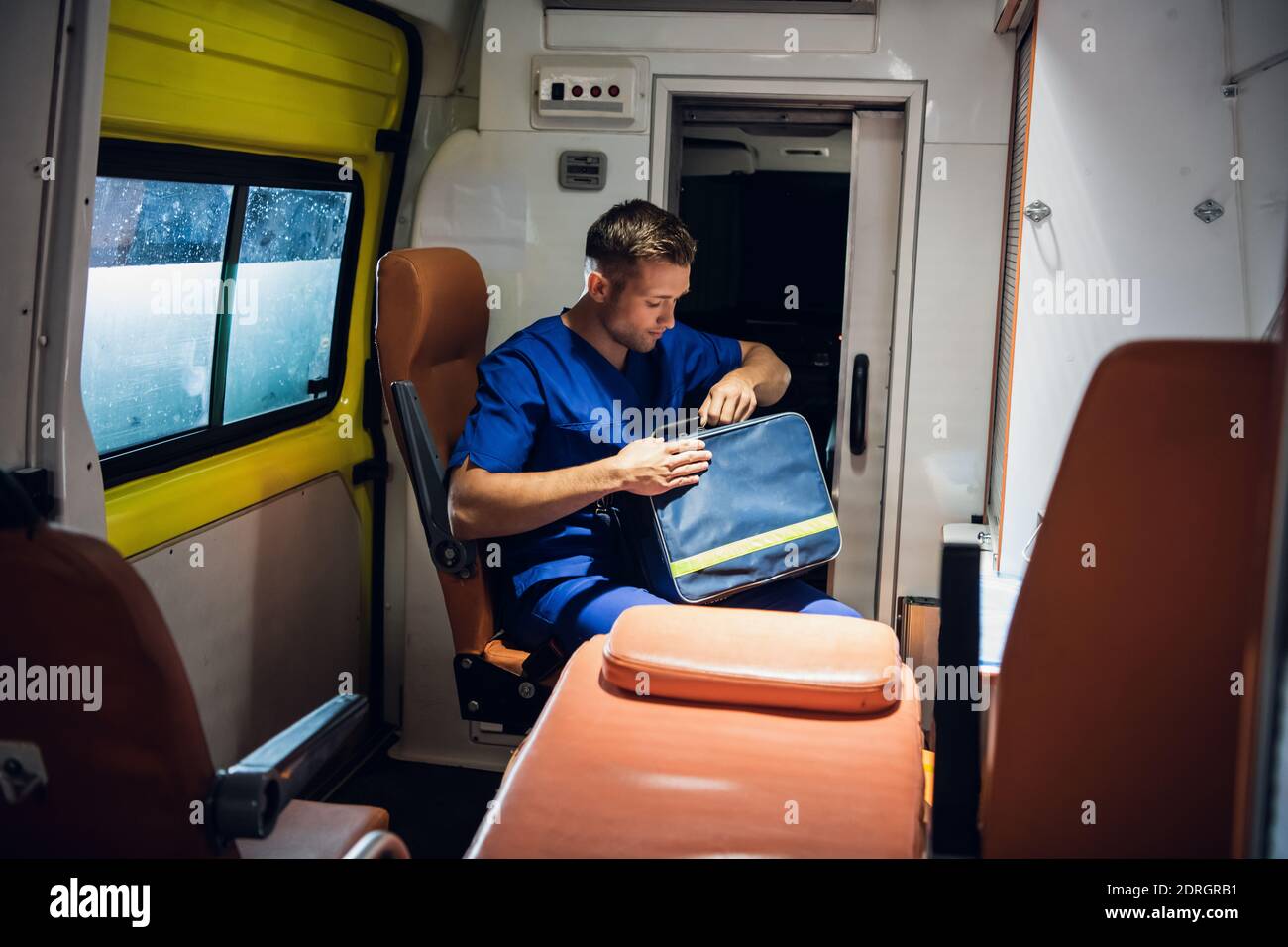 Paramedic on duty, checking his medical instruments in an ambulance ...