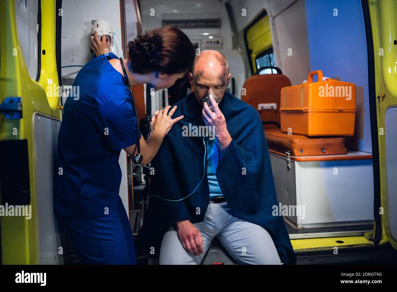 Medical worker providing psychological aid to a man rescued from the ...