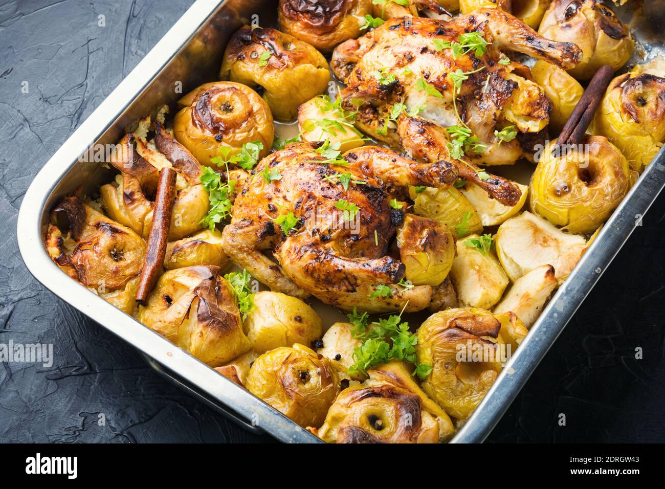 Delicious baked partridge with apples in tray.Homemade baked chicken ...