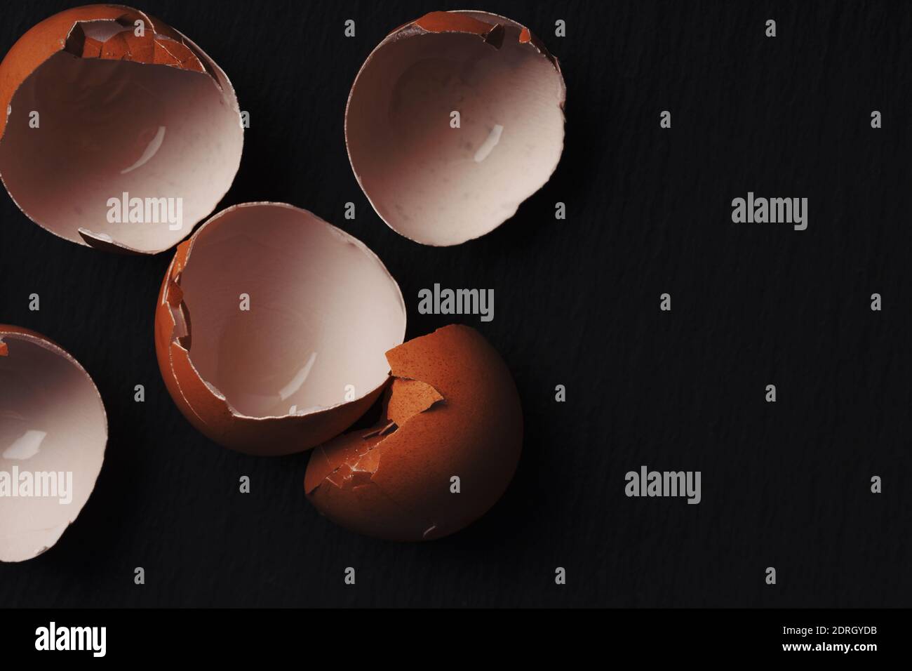 broken eggshell on black background . Copy space Stock Photo - Alamy