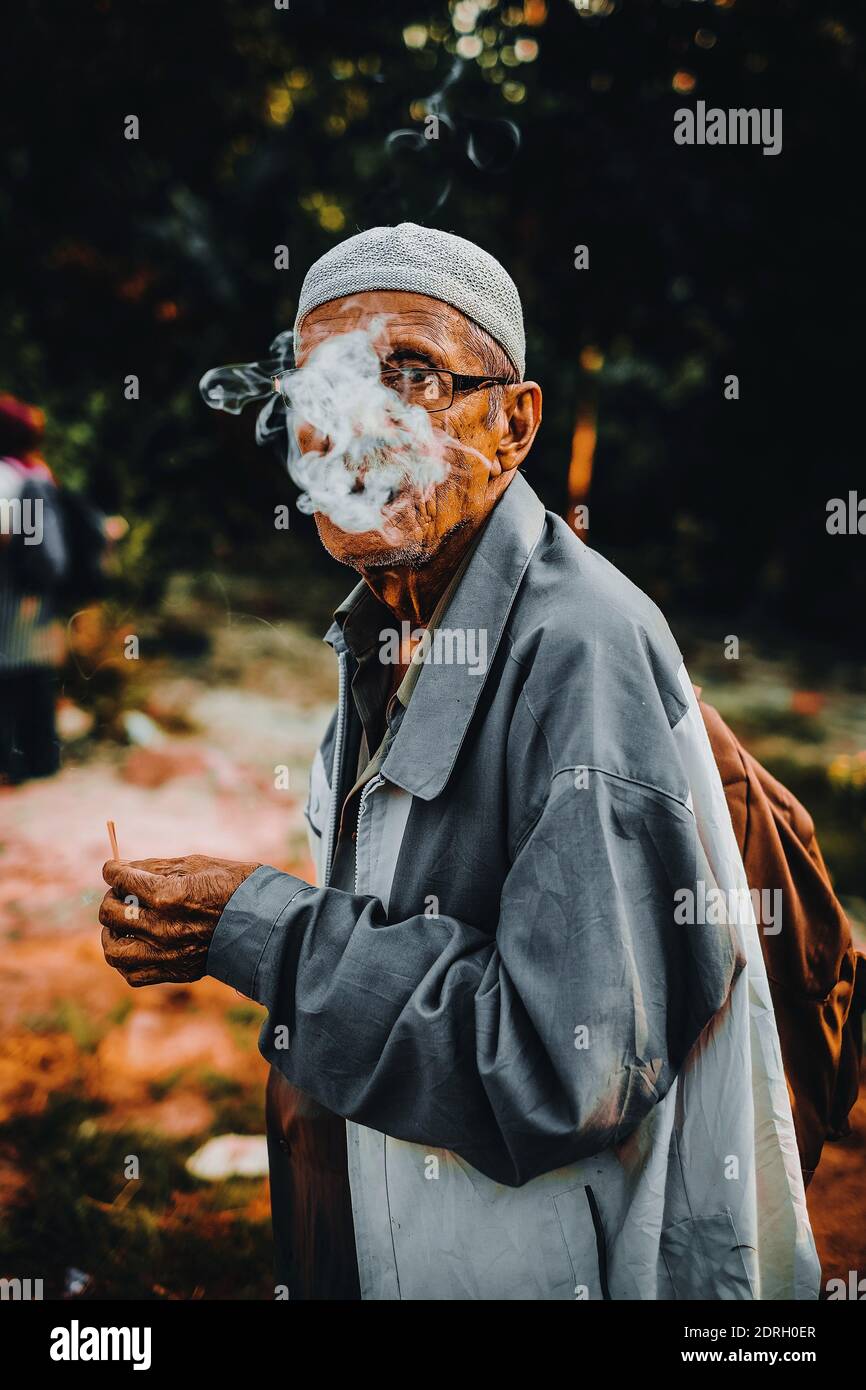 Man Exhaling Smoke While Standing Outdoors Stock Photo - Alamy