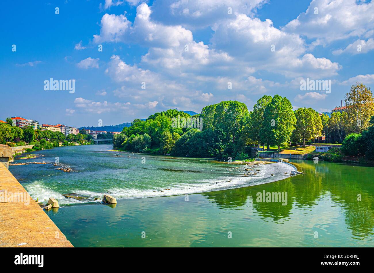 Po river in Turin city historical centre with water dam and green trees ...