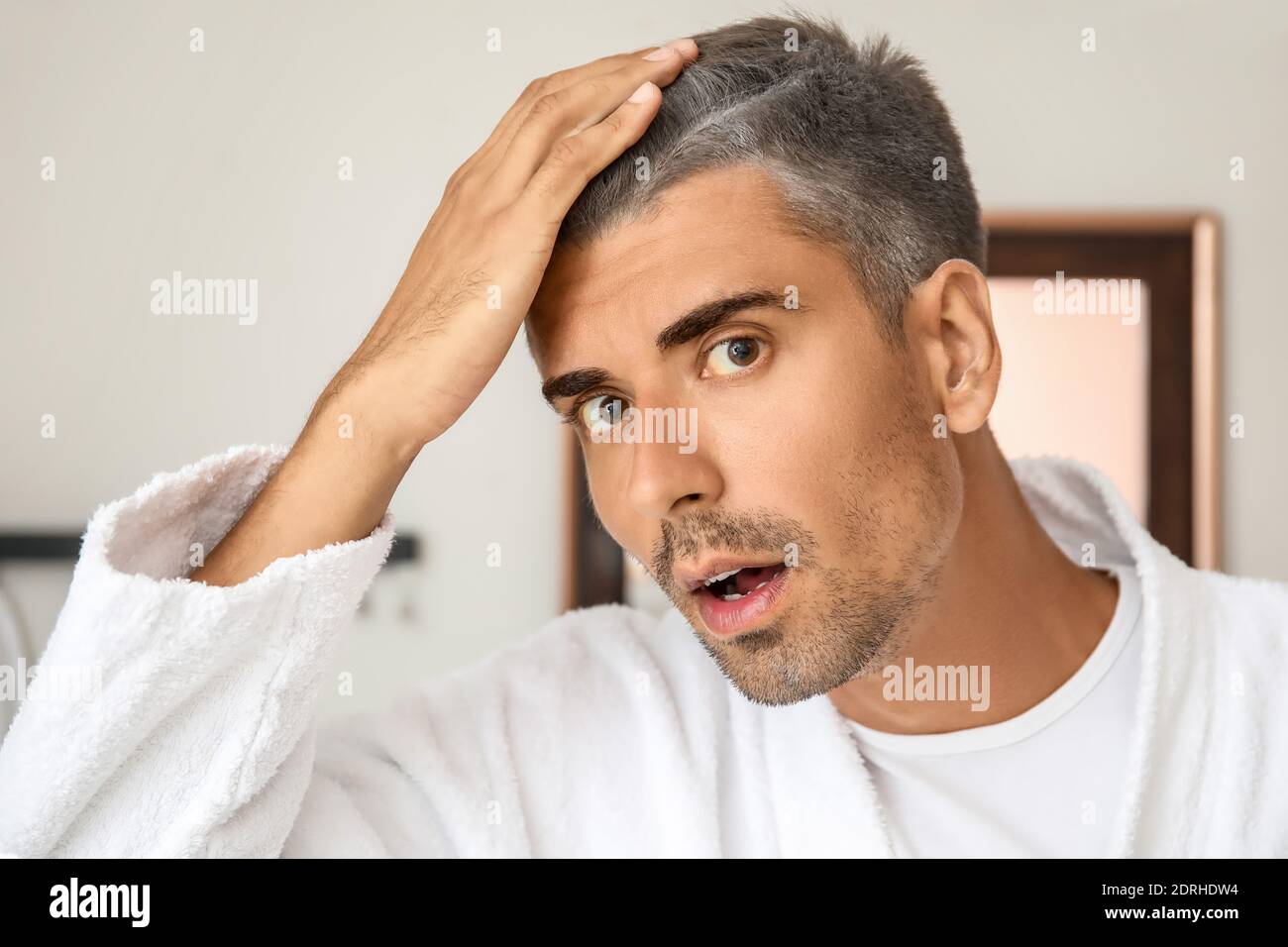 Stressed man with graying hair at home Stock Photo - Alamy