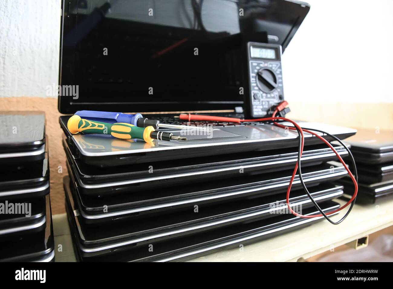 Laptops, screwdrivers, instrument testing and repair Stock Photo - Alamy