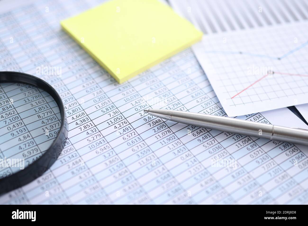 Papers with digital indicators magnifier and pen Stock Photo - Alamy