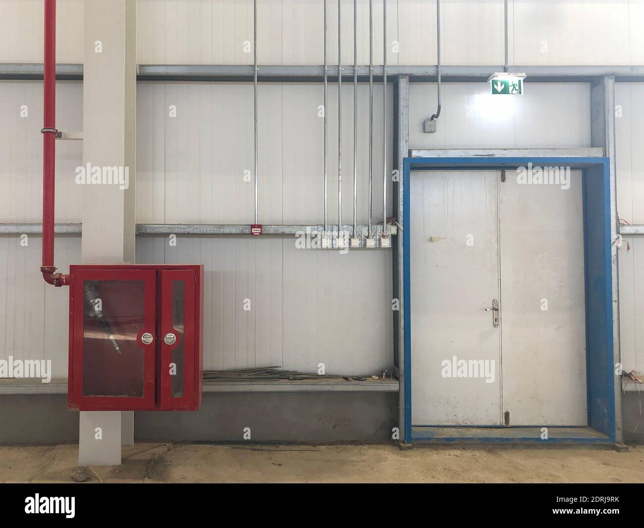 Fire extinguisher box with fire hose inside and emergency exit Stock ...