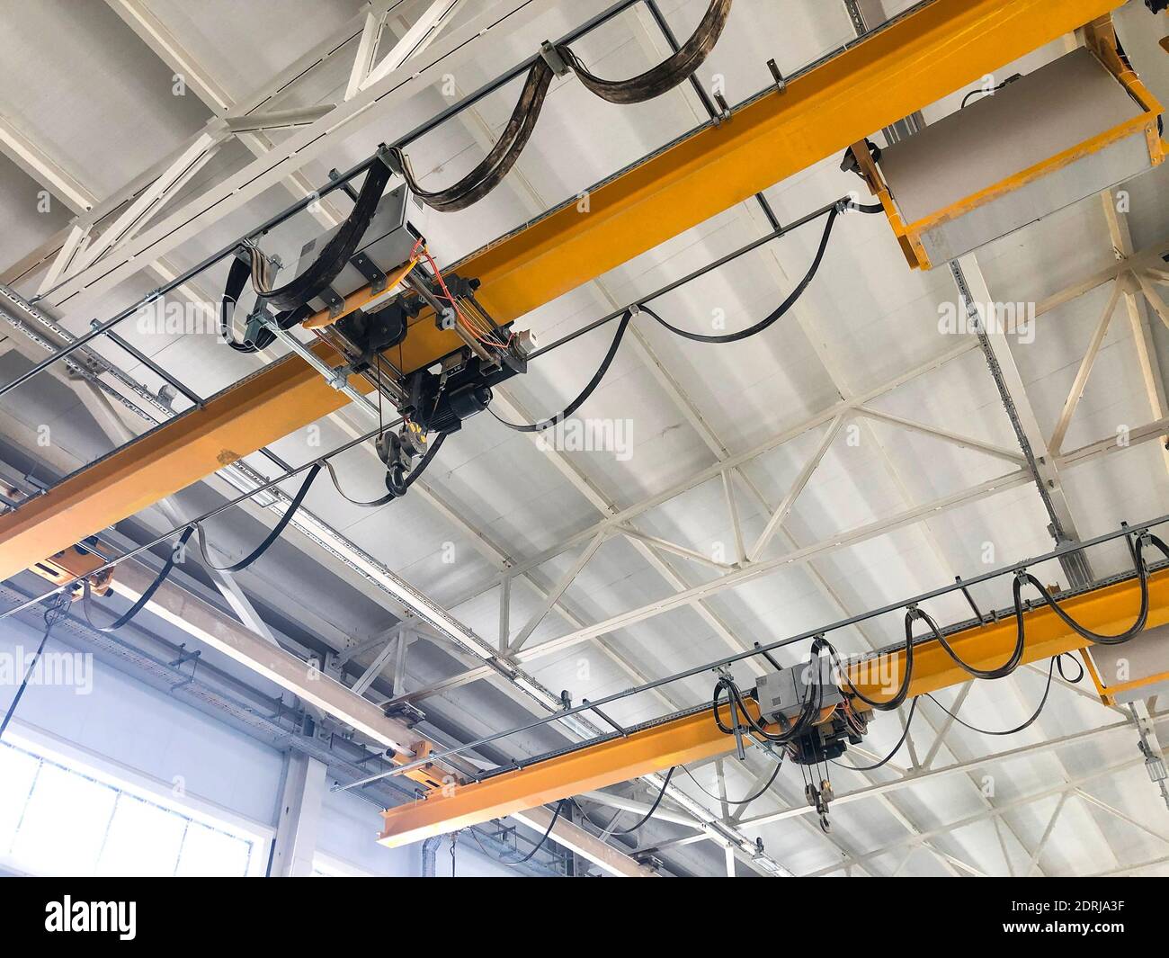 Overhead cranes inside industrial building. Bridge cranes inside hangar ...