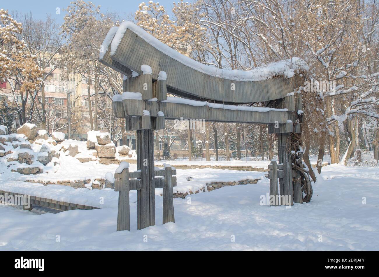 Beautiful architectural arch and large stones covered with snow in the ...
