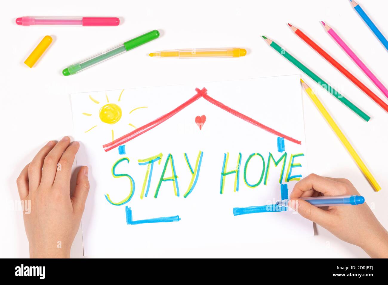Stay at home. Kid hands drawing picture with house and message Stay ...