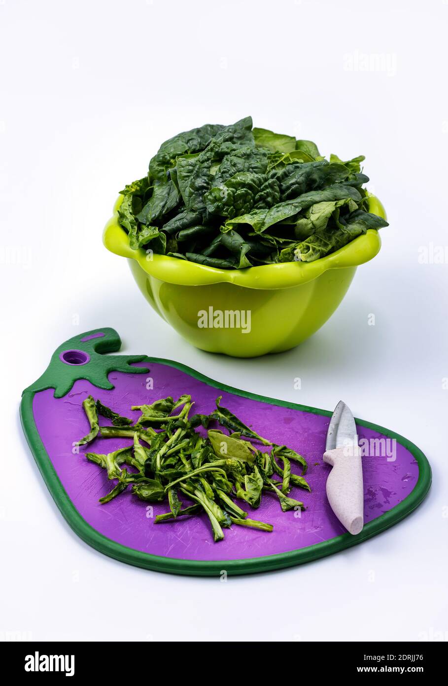 Fresh chopped spinach on a cutting board. Juicy green spinach, white ...