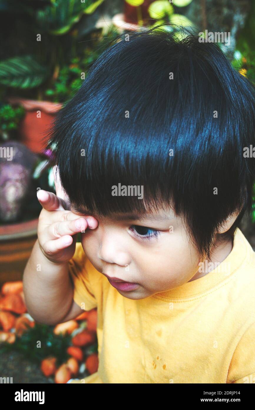 Boy rubbing head hi-res stock photography and images - Alamy