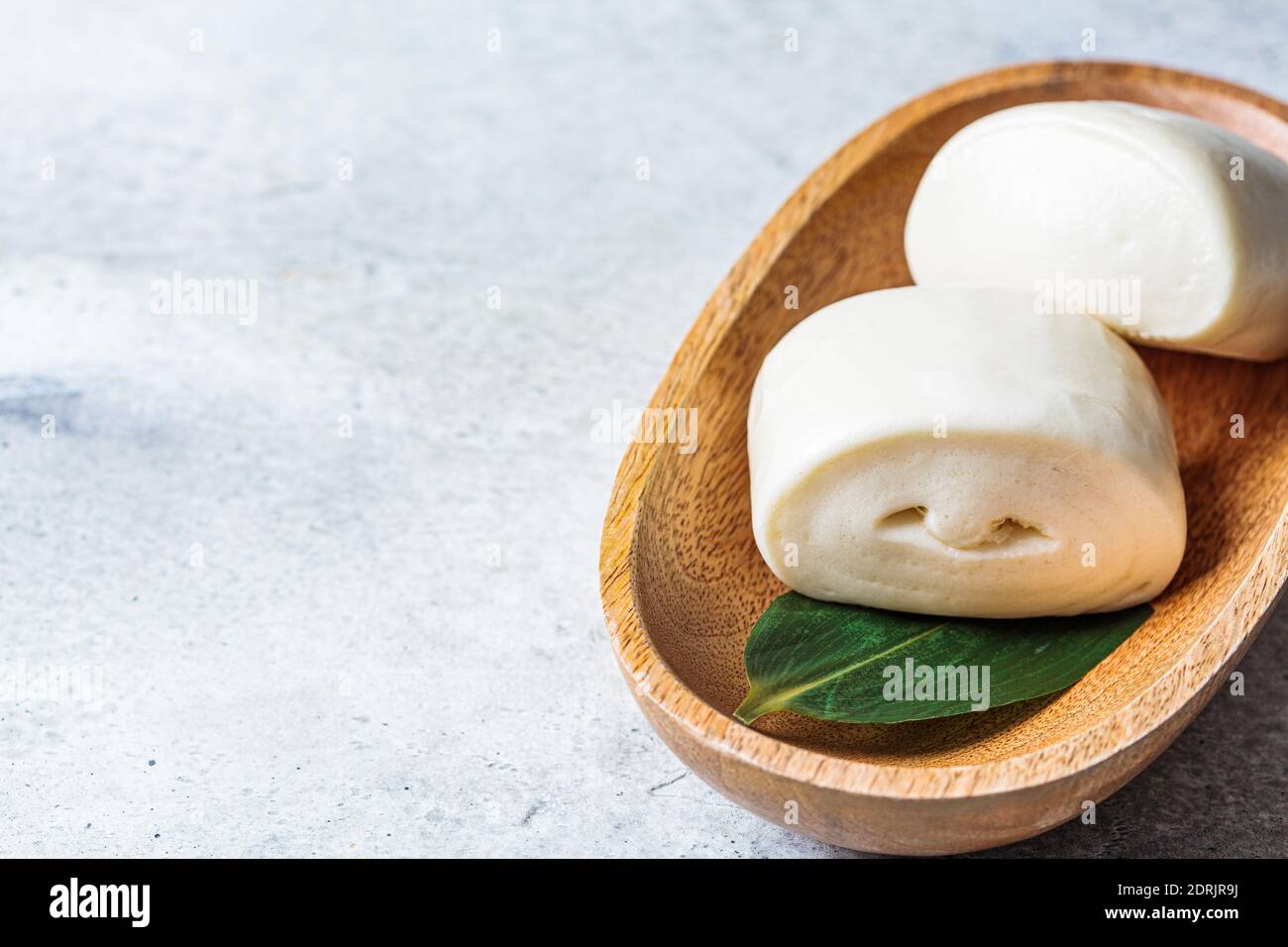 Chinese steamed rice roll bun on a wooden plate. Chinese food concept ...