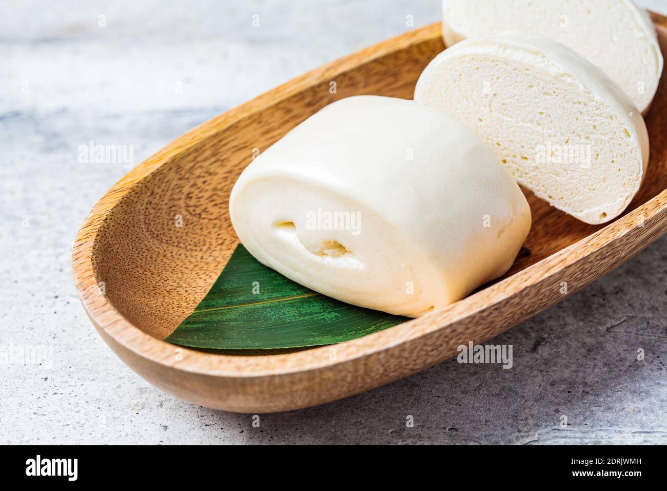 Chinese steamed rice roll bun on a wooden plate. Chinese food concept ...