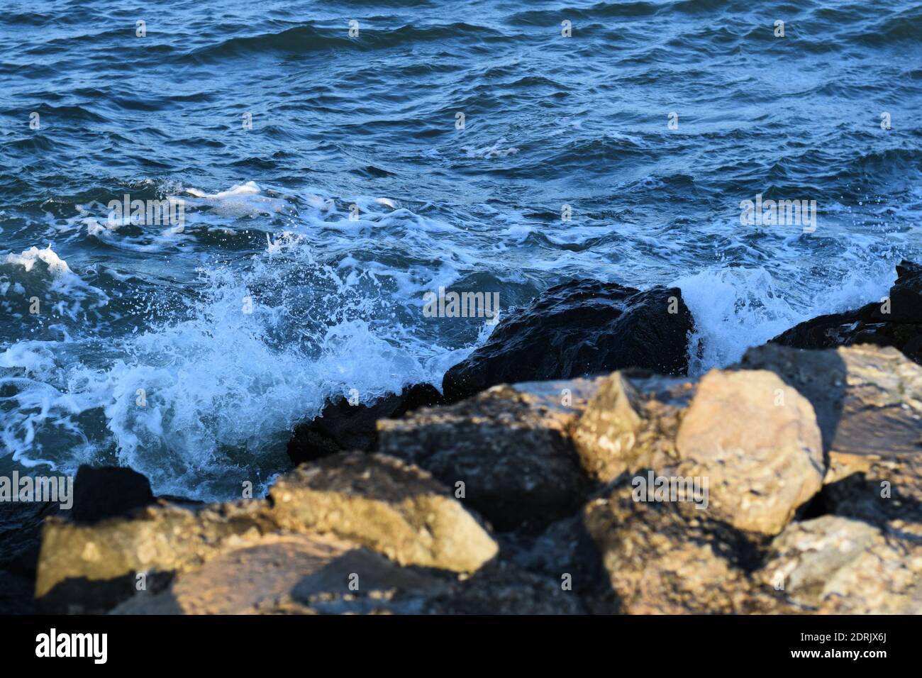 Beautiful sea waves crashing on rocks near the beach Stock Photo - Alamy