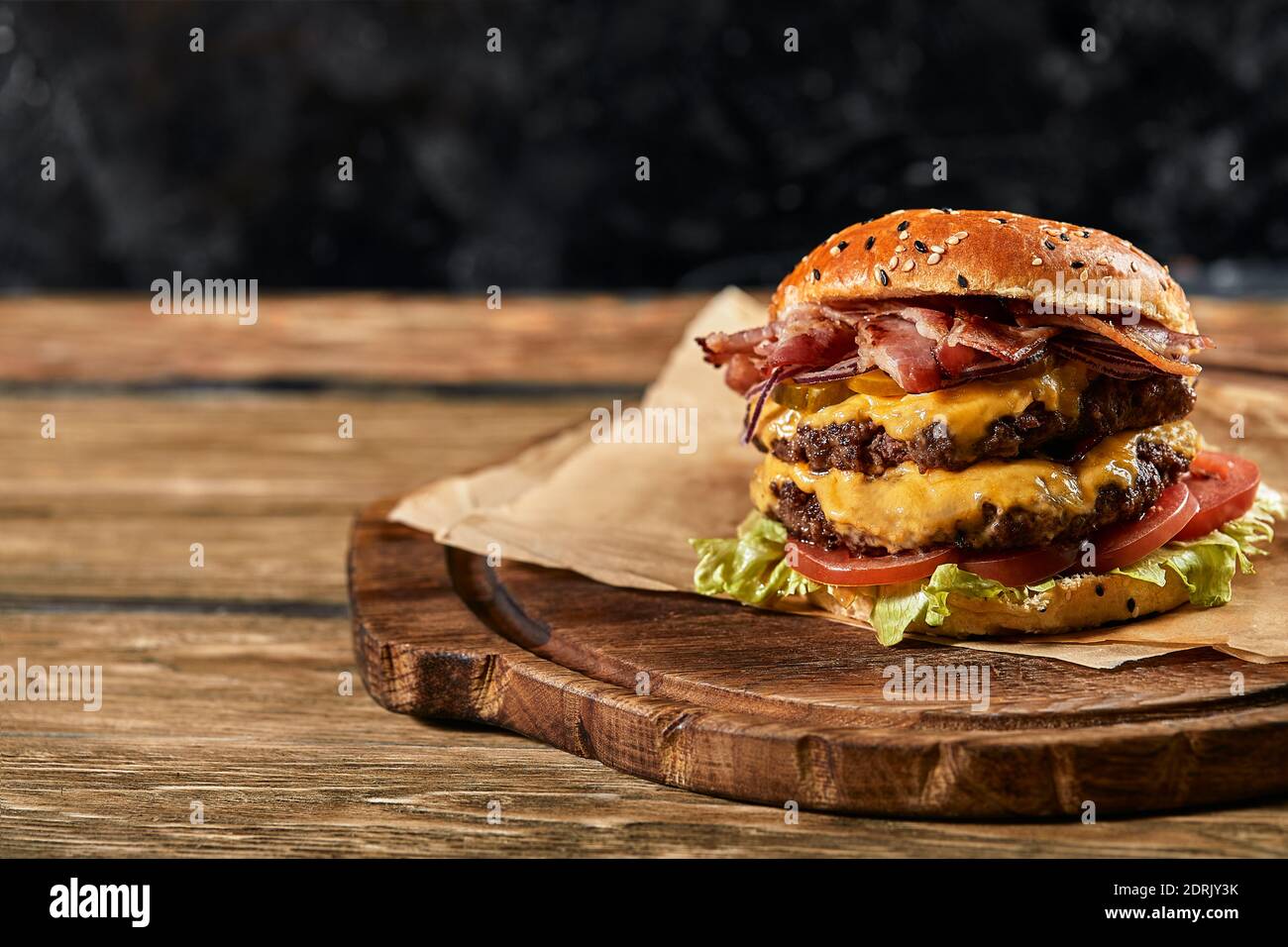 The concept of American fast food. A juicy American burger with two ...