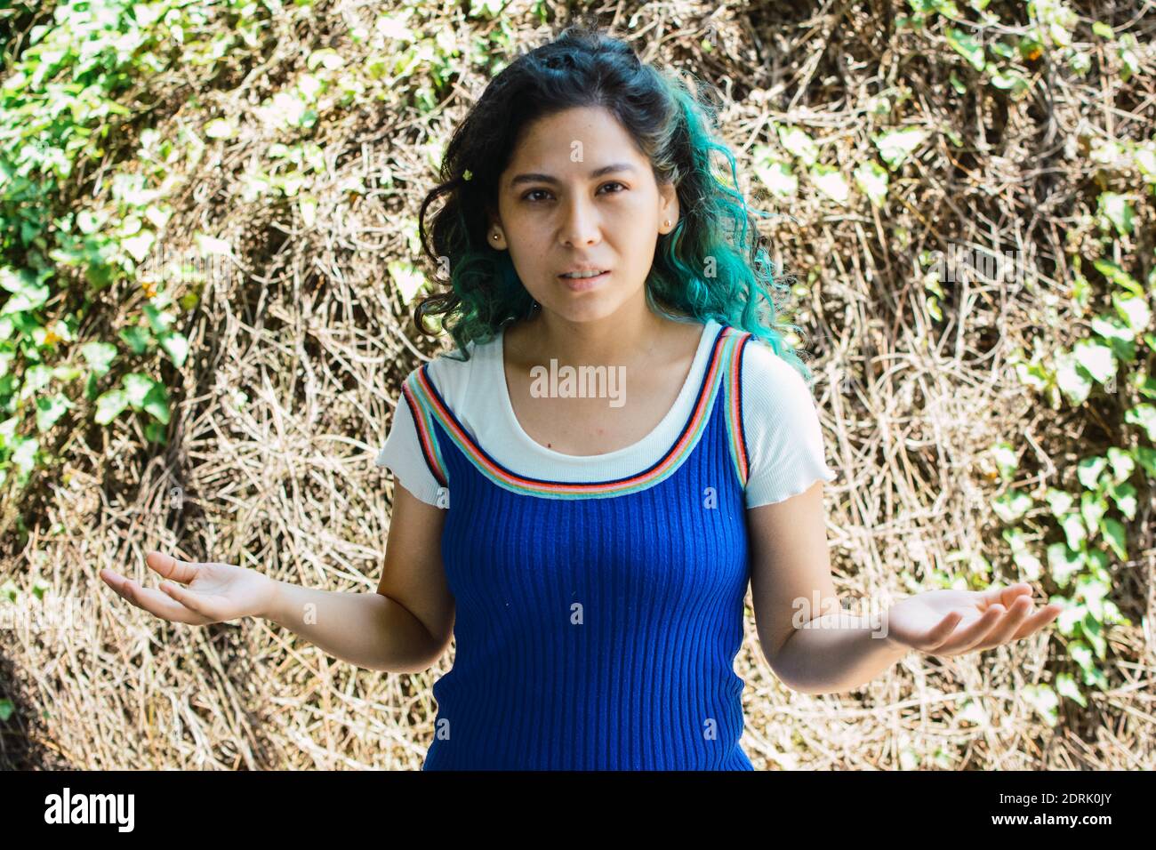 A shallow focus of a young Hispanic woman with a questioning expression ...