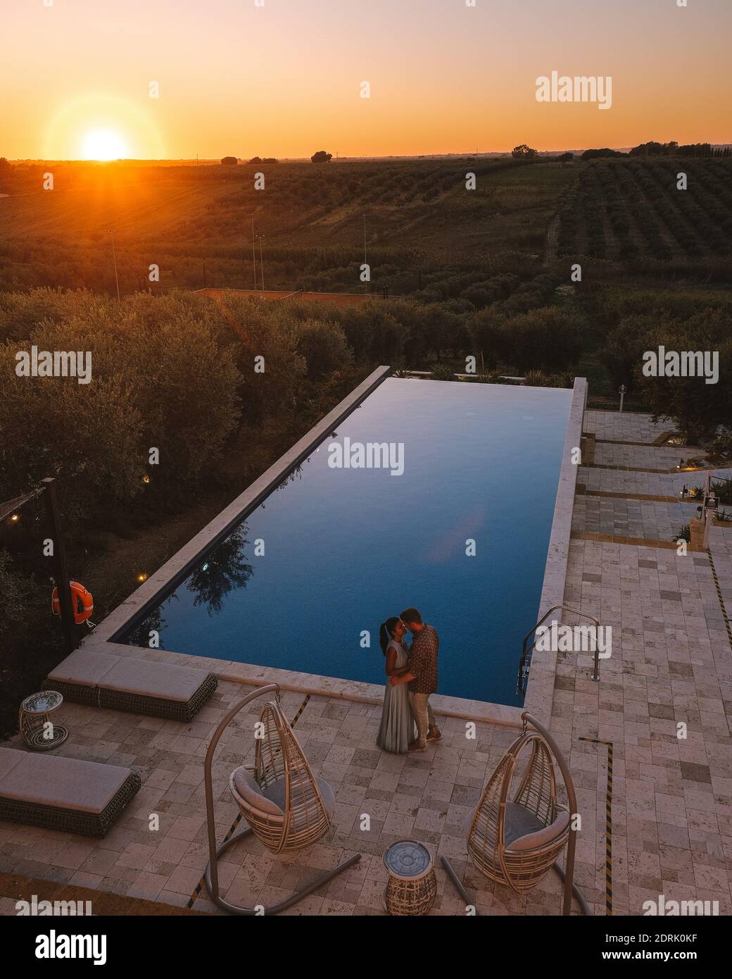 couple on vacation at luxury resort in Sicily during sunset by the ...