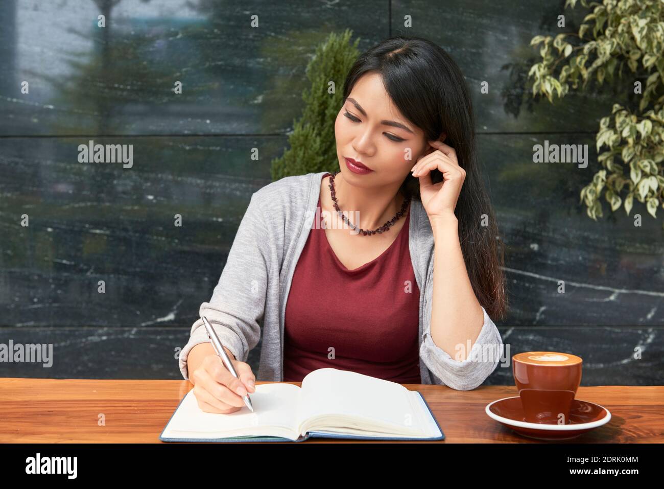 Woman writing in journal cup hi-res stock photography and images - Alamy