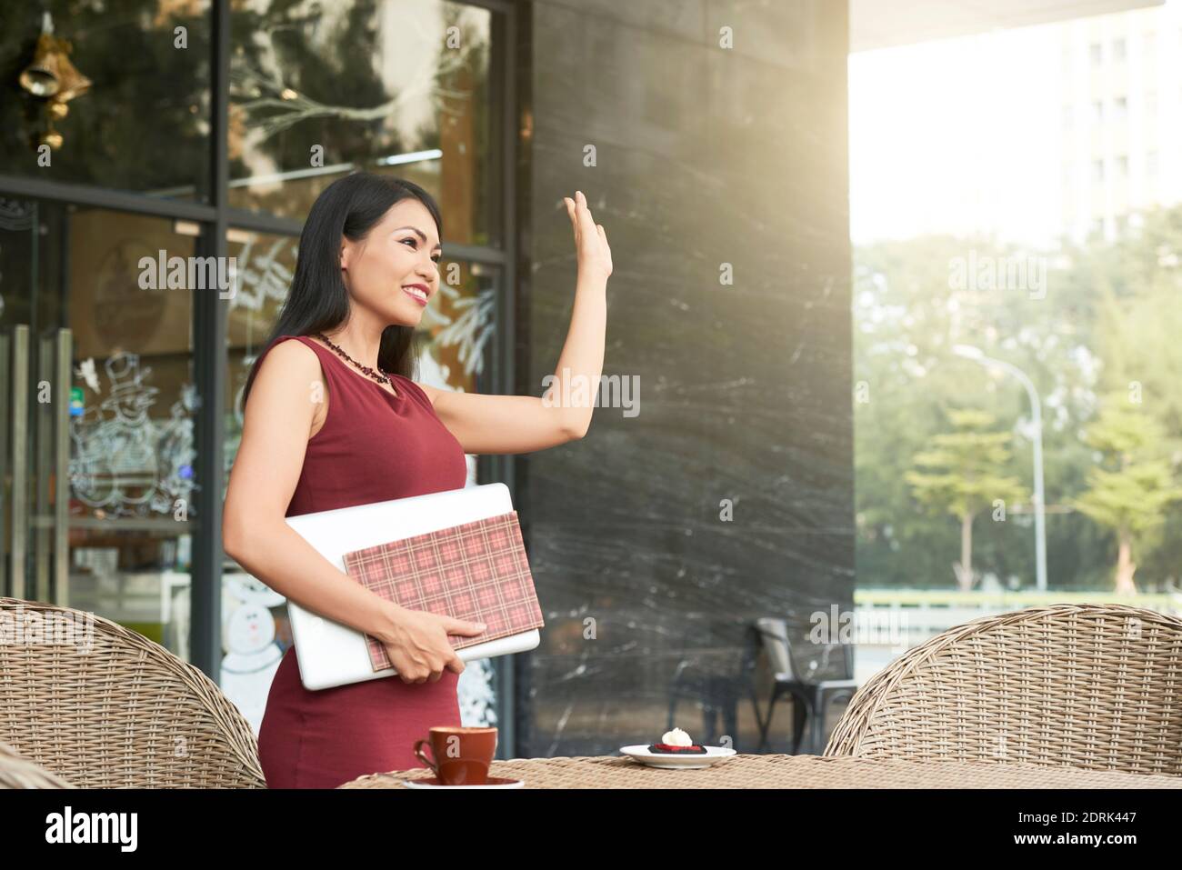 Business lady waving with hand Stock Photo - Alamy