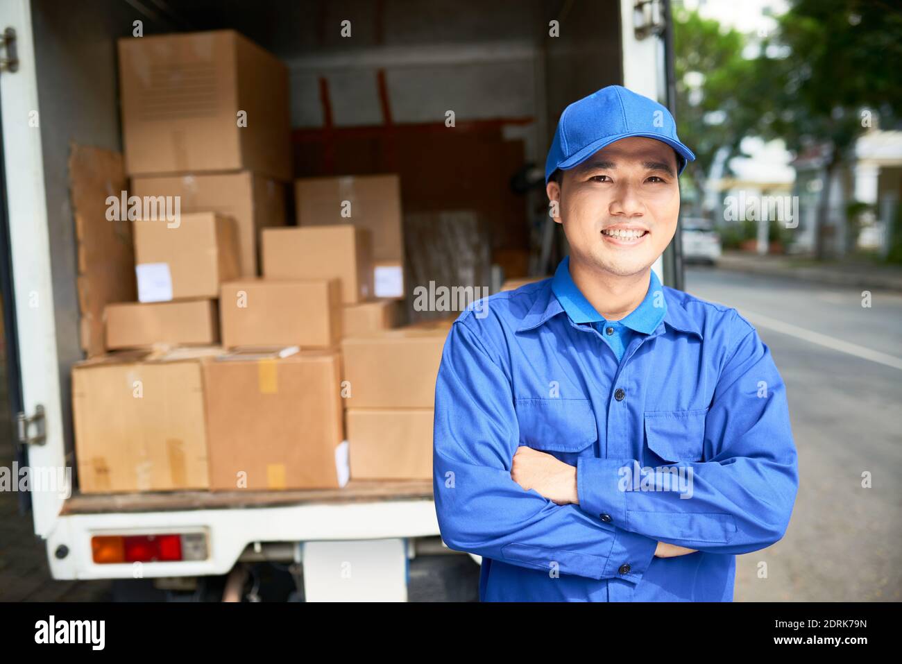 Smiling young delivery truck driver Stock Photo - Alamy