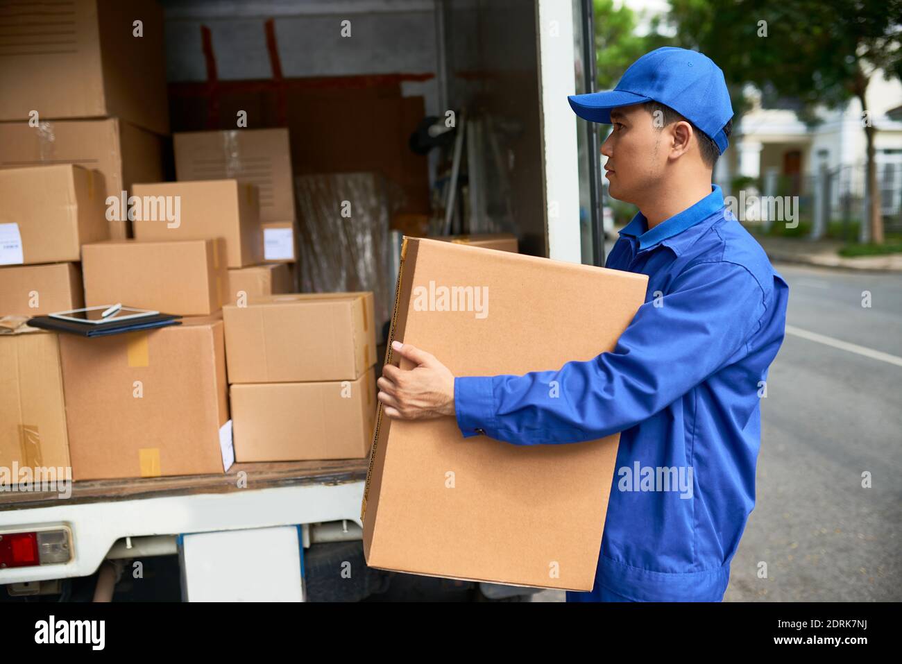 Delivery man loading truck Stock Photo - Alamy