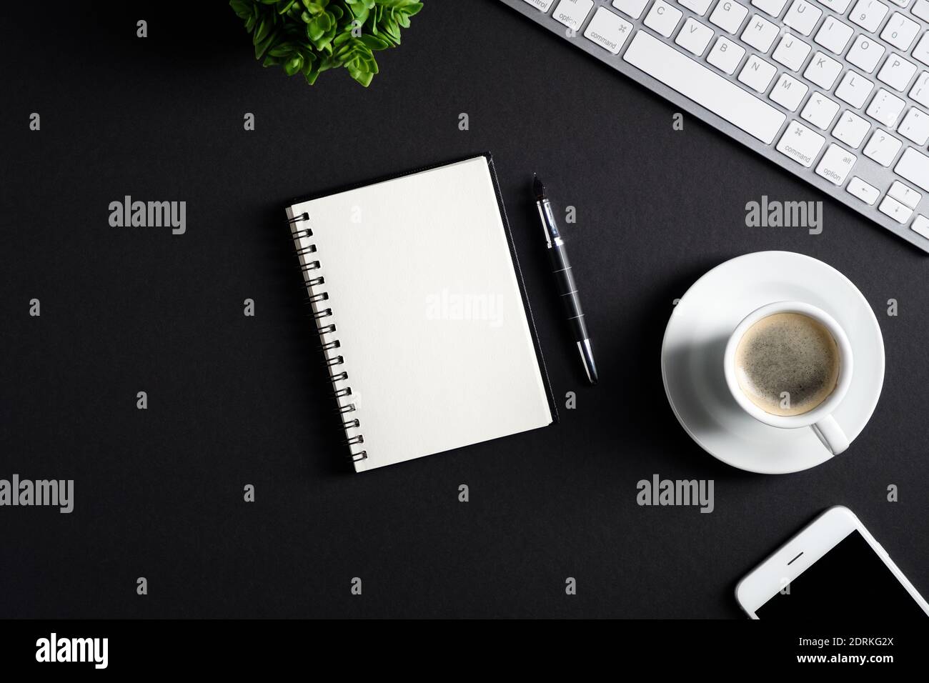 Black office desk table with paper notepad, pen, cup of coffee ...
