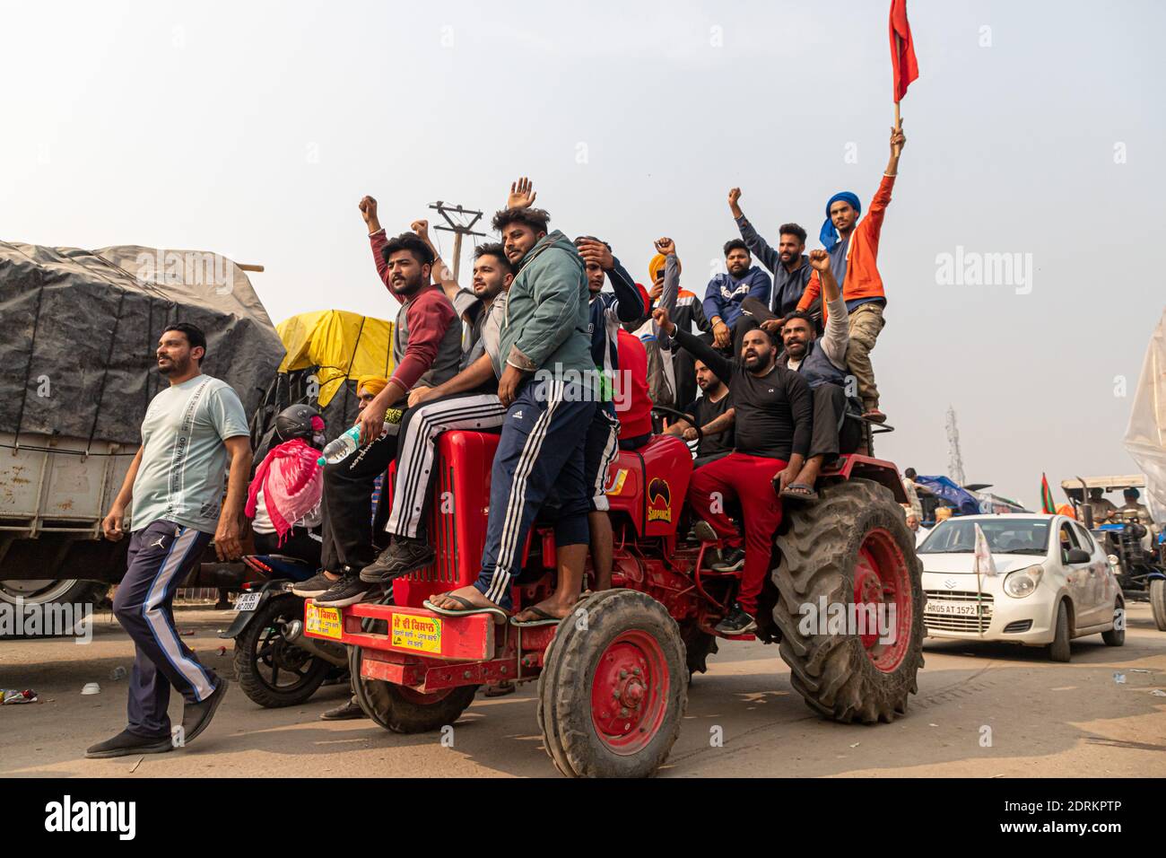 farmers are protesting on their tractor with flags and slogans at delhi ...
