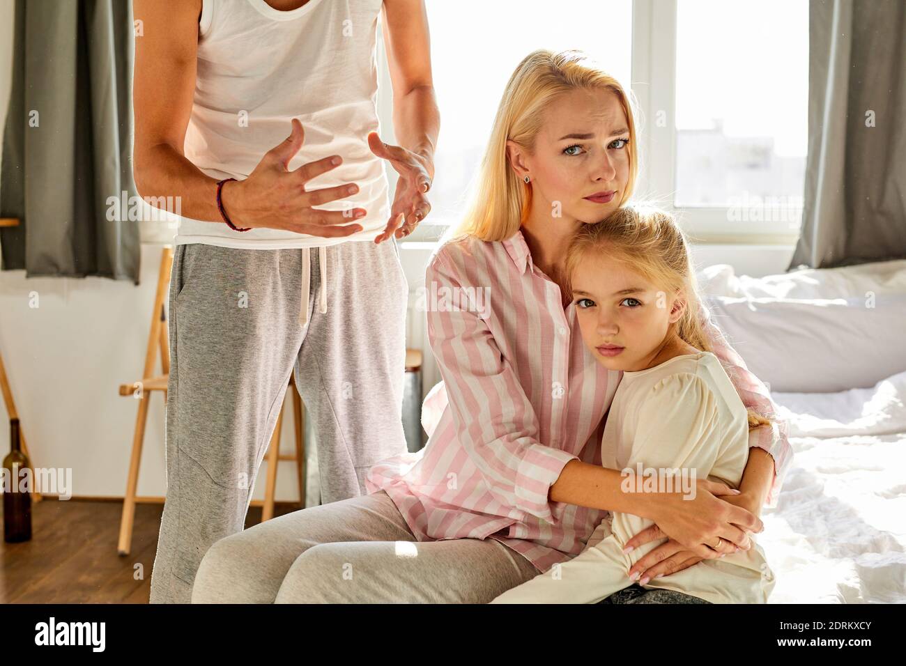 angry father scolds daughter and wife, family problems. scared child ...