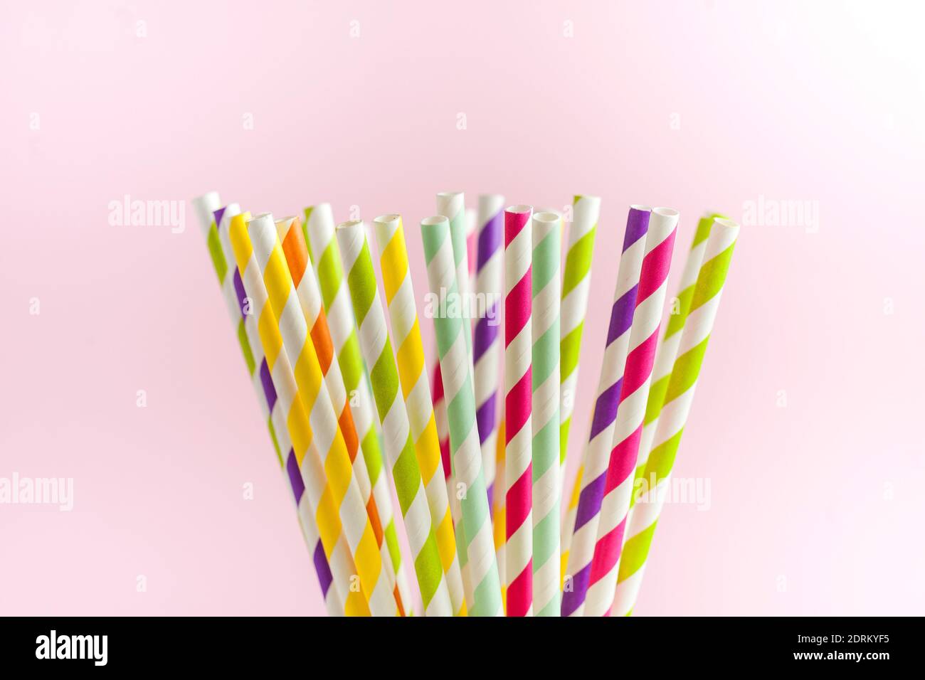 Multi-colored striped paper tubes for drinks, cocktails. The concept of ...