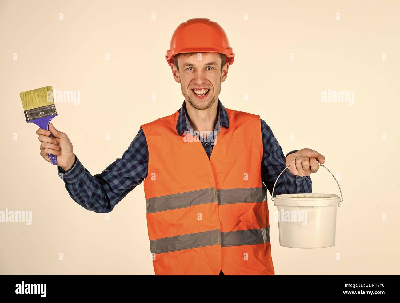 tools for repair. young man in hard hat. man builder use paiting brush ...