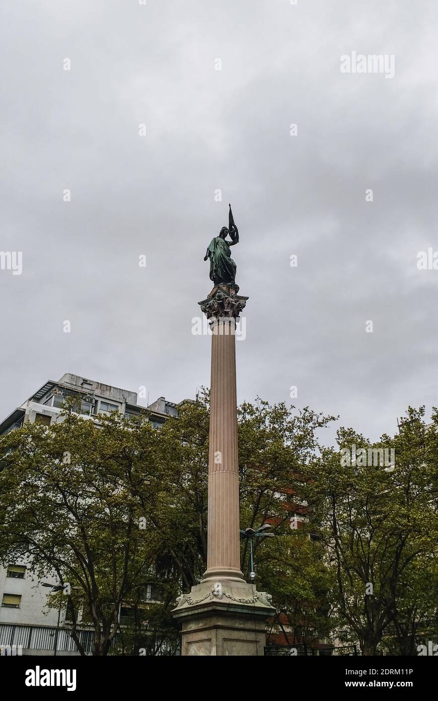 A vertical shot of a column statue in a park in Montevideo, Uruguay ...