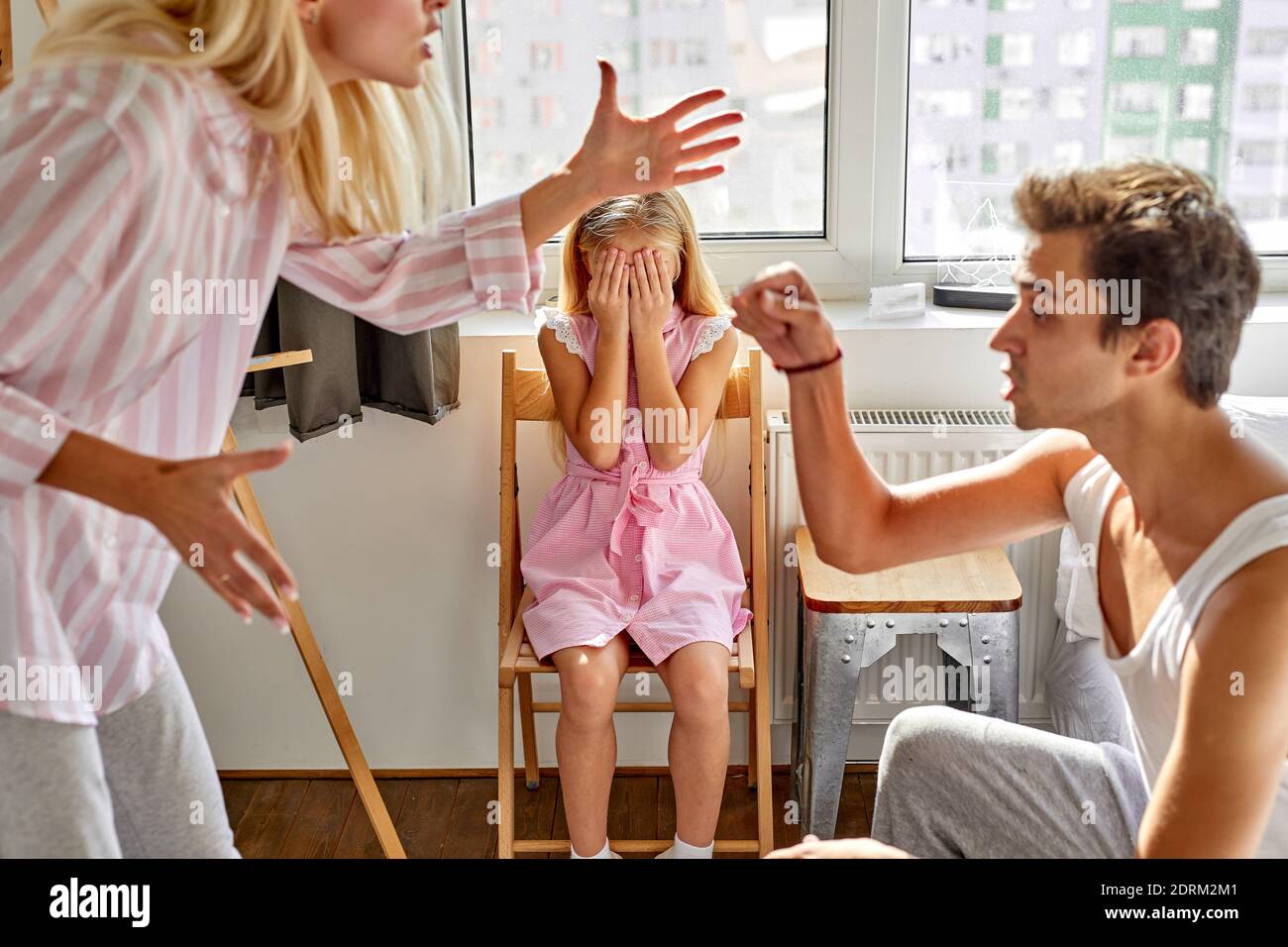 kid girl is suffering from quarrels between parents in the family at ...
