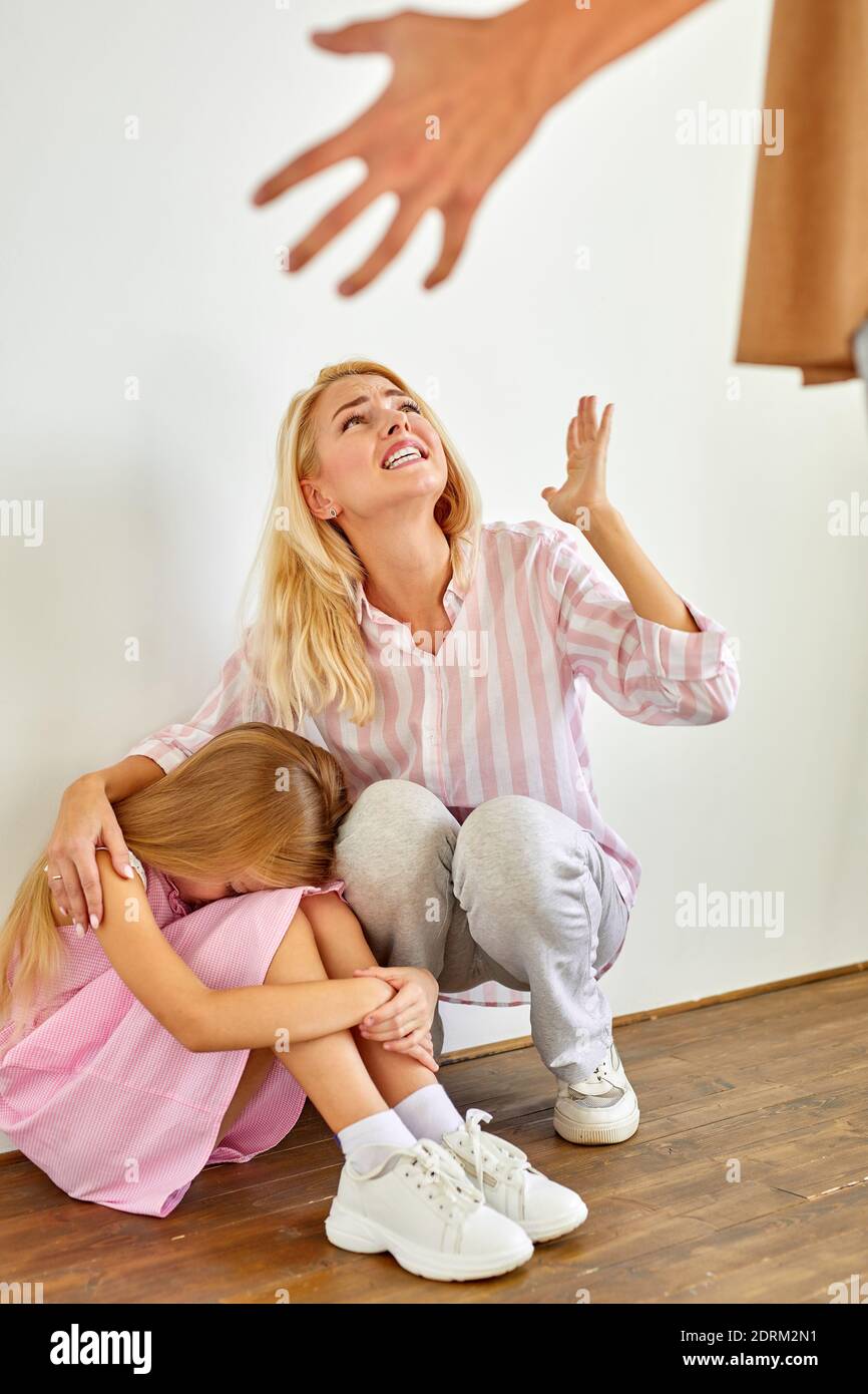 angry father scolds daughter and wife, family problems. scared child ...