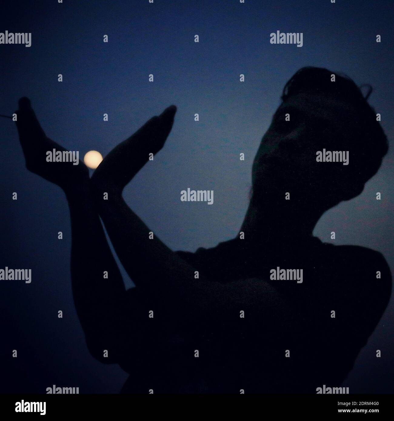 Holding the moon illusion hi-res stock photography and images - Alamy