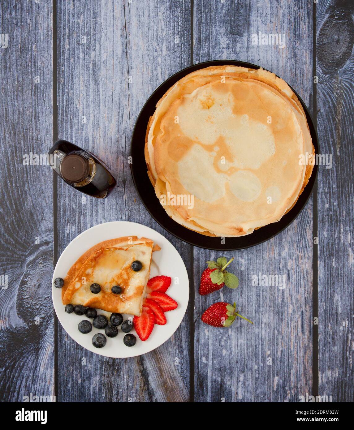 A top view of crepes with berries and syrup Stock Photo - Alamy