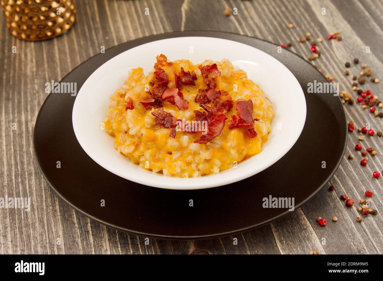 A closeup shot of a bowl of pumpkin and pear porridge with bacon Stock ...
