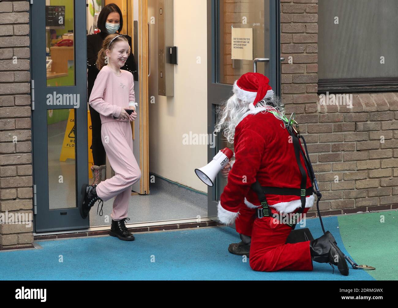 A man dressed as Santa Claus speaks to Darcie Jones, aged 8, as he ...
