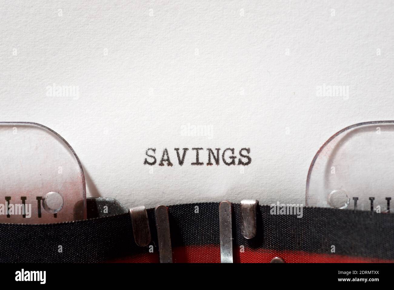 Savings word written with a typewriter Stock Photo - Alamy