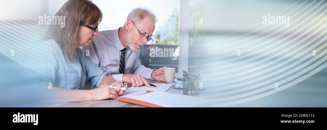 Two mature business people working together in office. panoramic banner ...