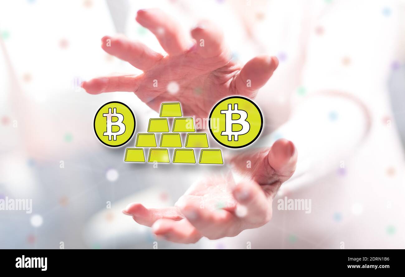 Bitcoin virtual gold concept between hands of a woman in background ...