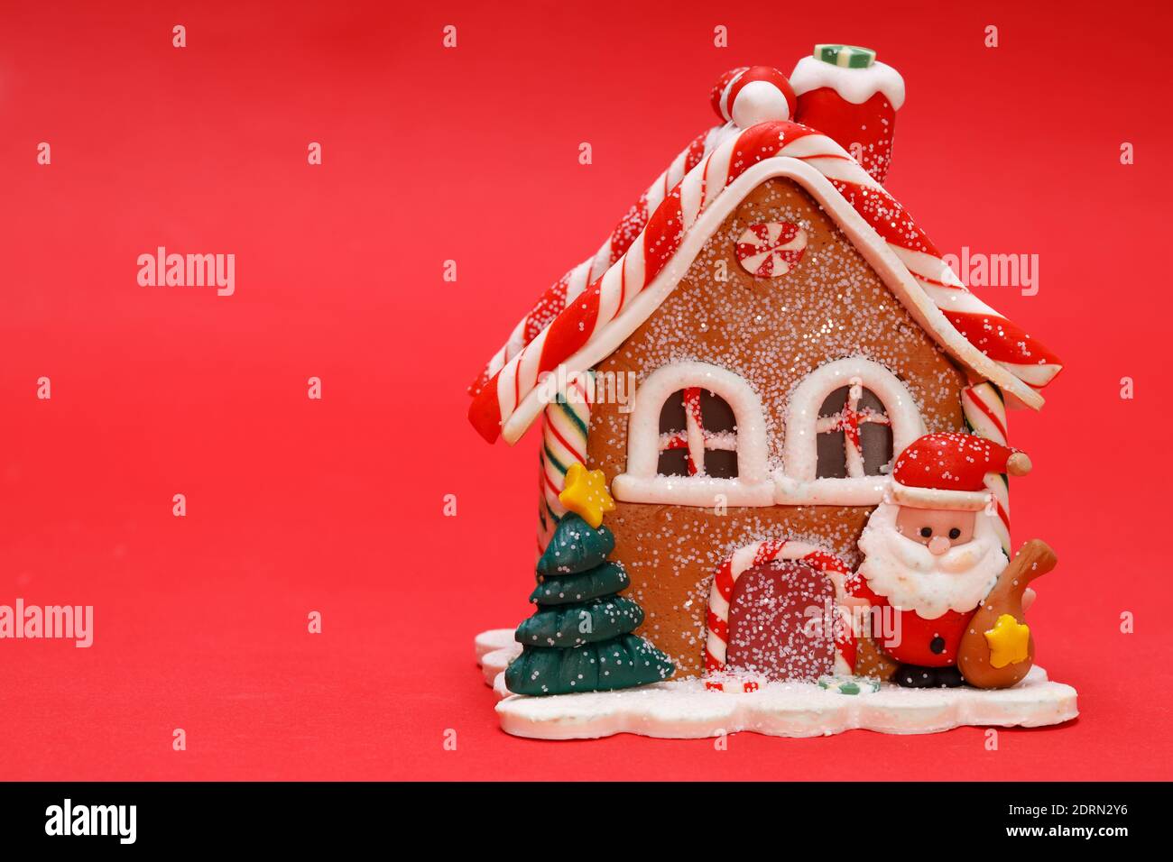 christmas house with santa claus on a red background Stock Photo - Alamy