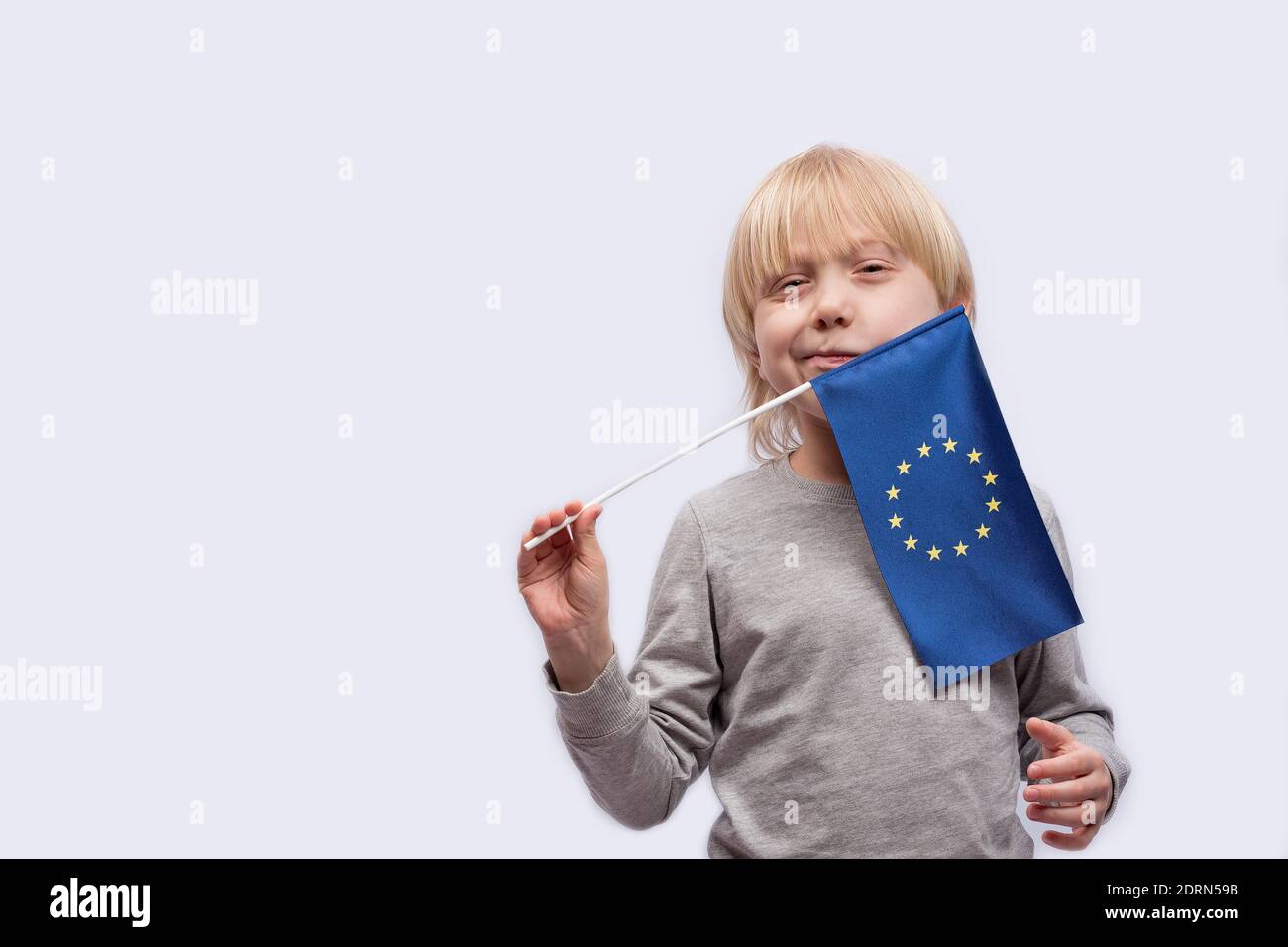 Pensive boy holding flag of European Union. Education in Europe Stock ...