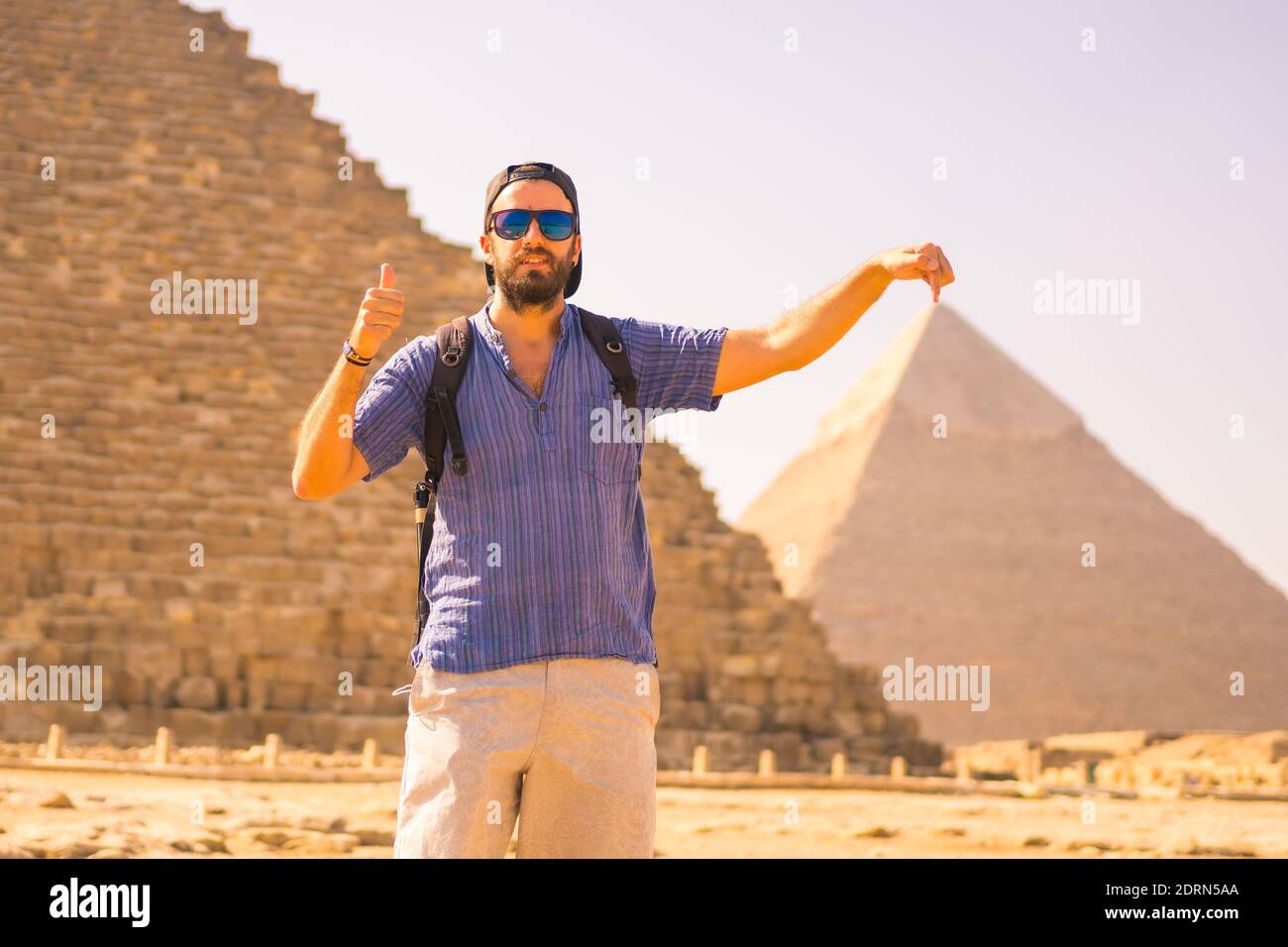 A male Caucasian photographer posing in front of the great pyramids of ...