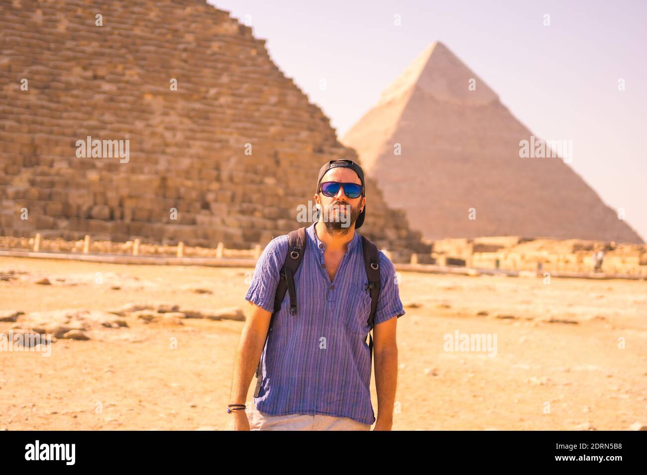 A male Caucasian photographer posing in front of the great pyramids of ...