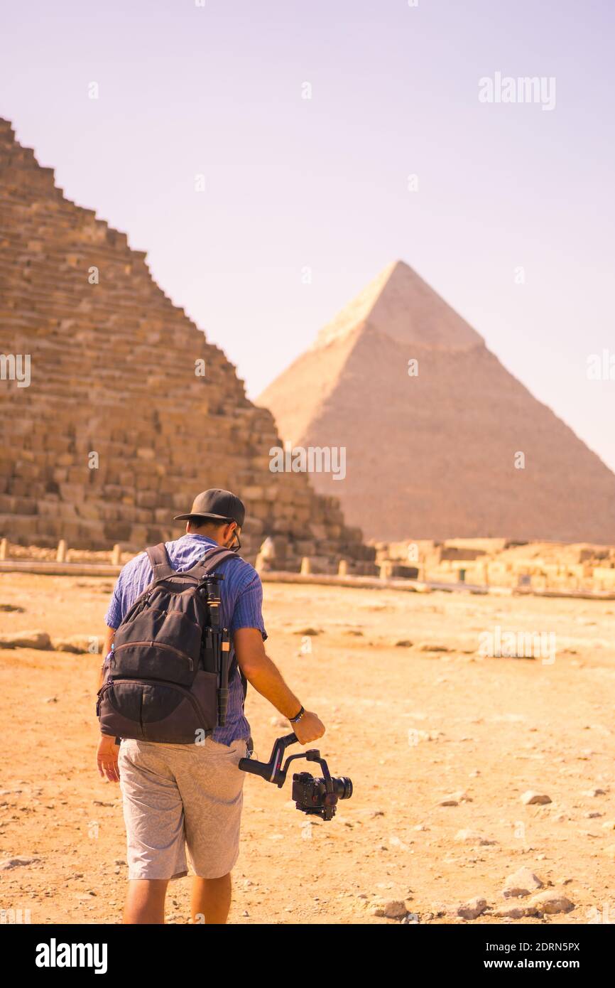 A male Caucasian photographer posing in front of the great pyramids of ...