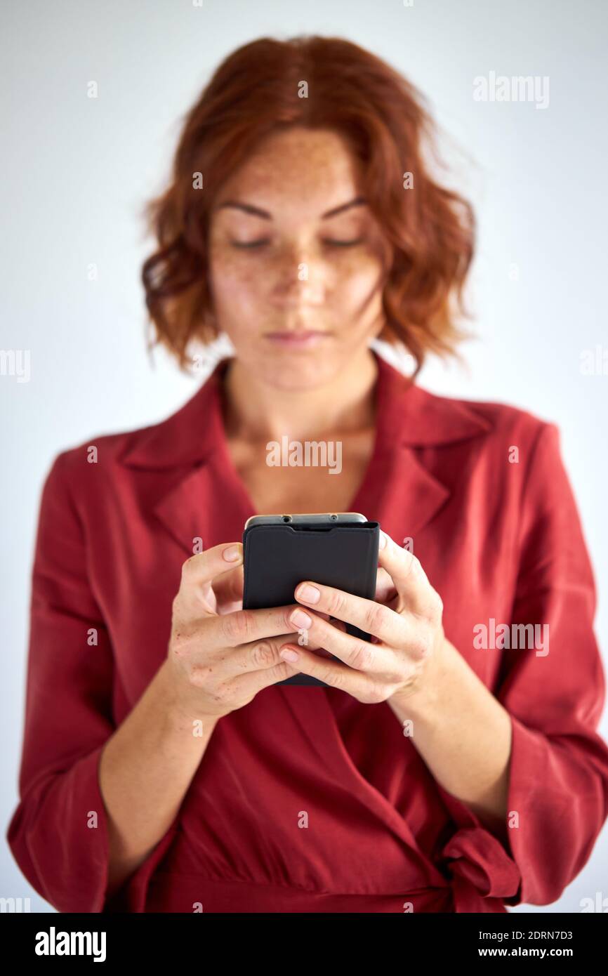 serious pretty female with natural red hair chatting with someone ...