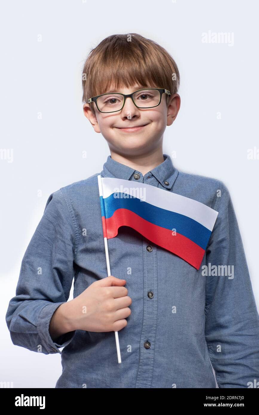 Portrait of teenage boy with flag of Russia in hands isolated on white ...