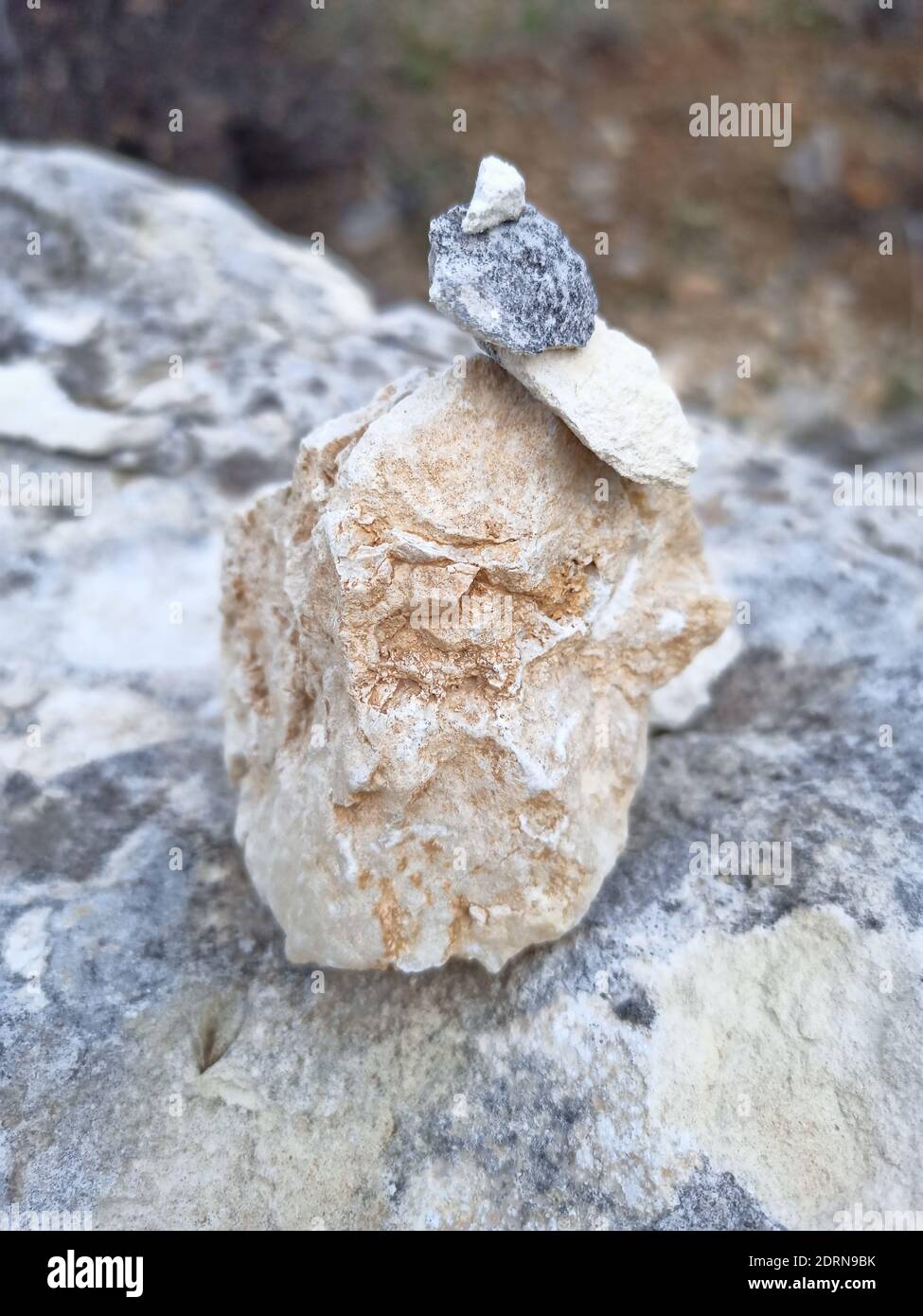 A vertical shot of different sizes of stones standing on each other on ...