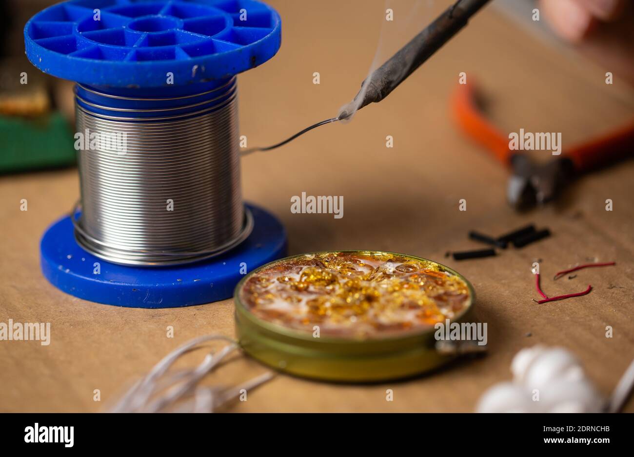 Senior man soldering a wires, repairing an electronic Stock Photo - Alamy